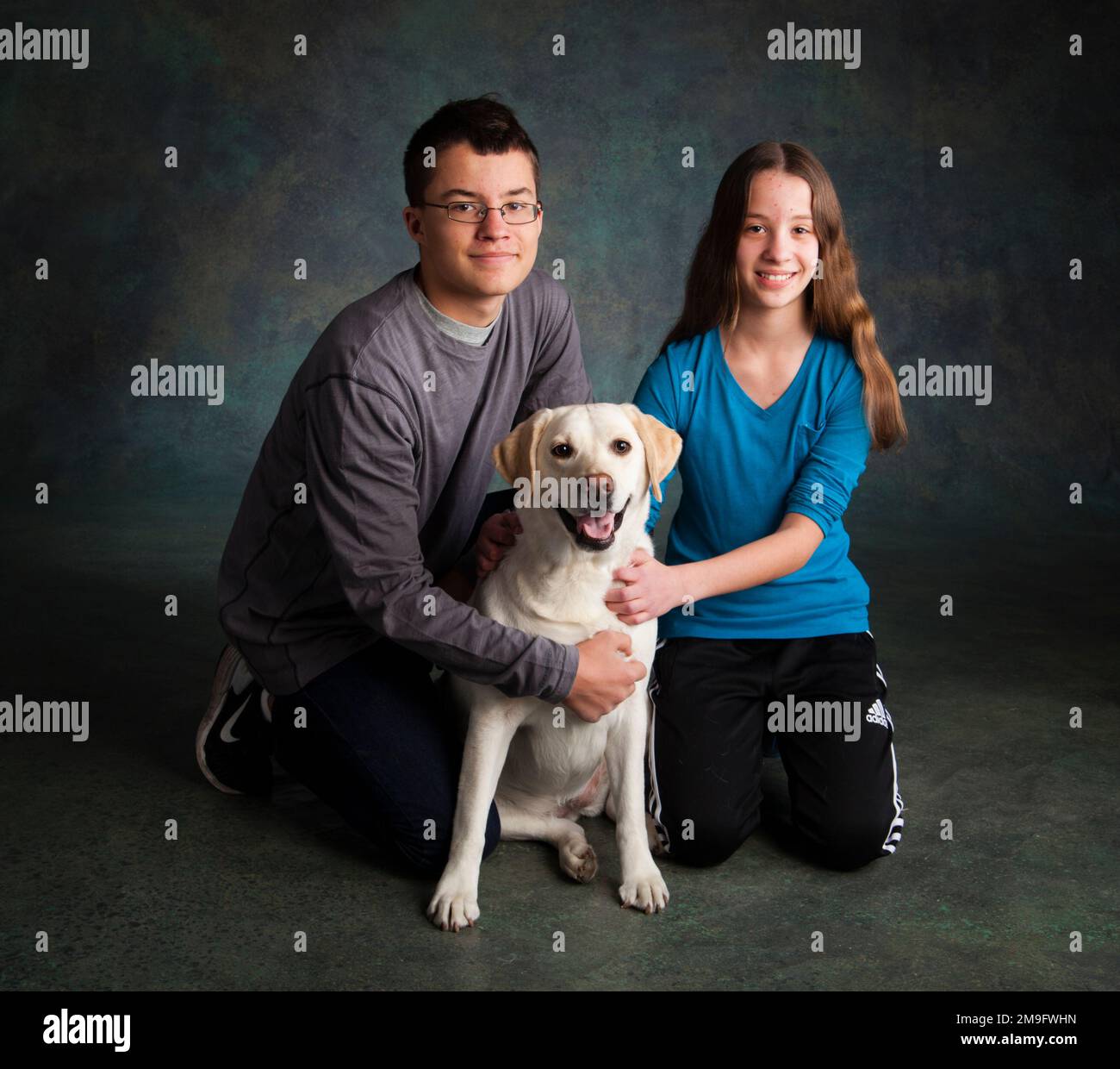 Portrait of Labrador with owners Stock Photo - Alamy