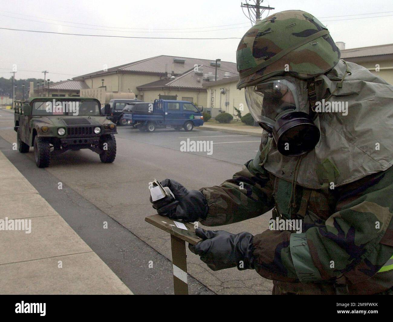 Dressed in Mission-Oriented Protective Posture response level 4 (MOPP-4 ...