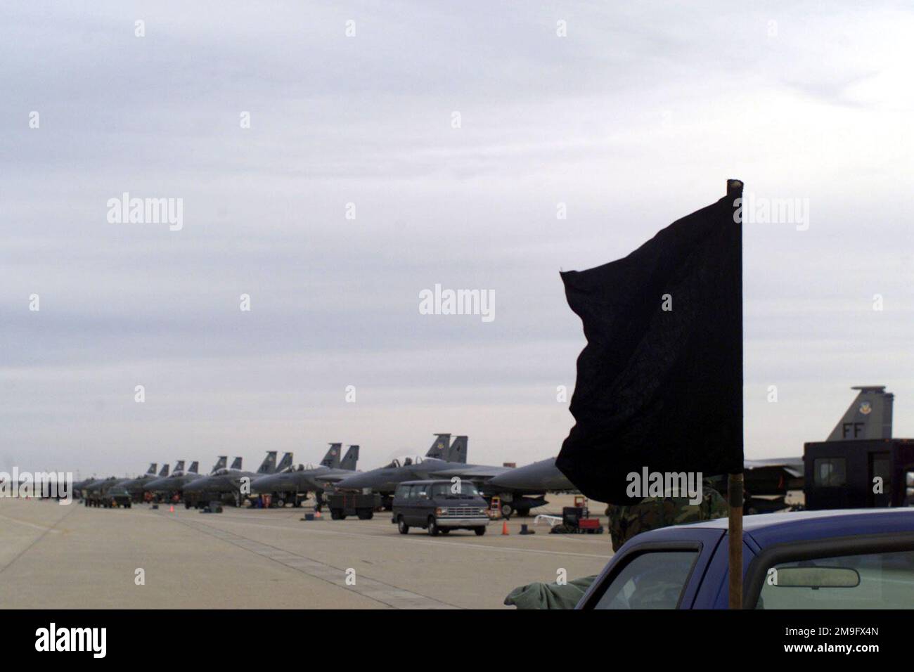 A black flag on a flightline vehicle indicates an Alarm Black is in ...