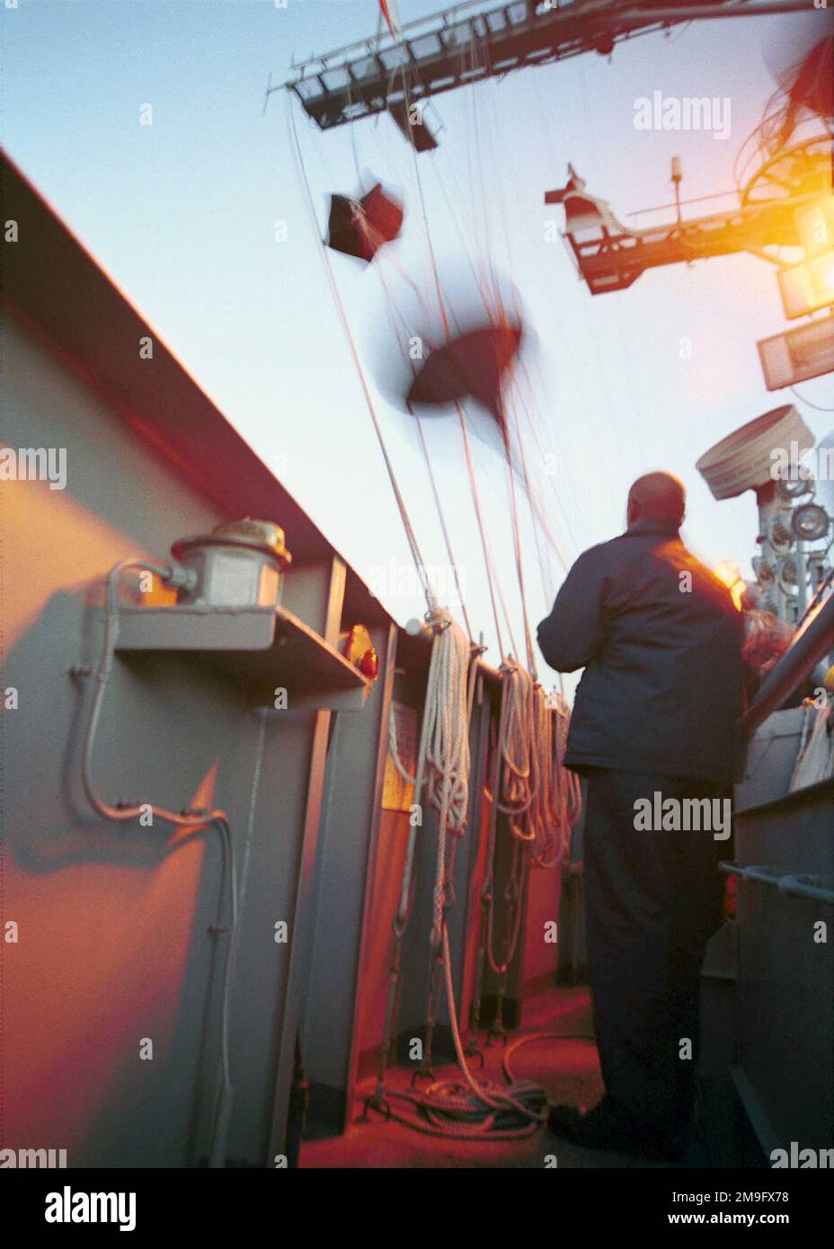 Signalman Third Class Higer Johnston runs the naviagational signal ...
