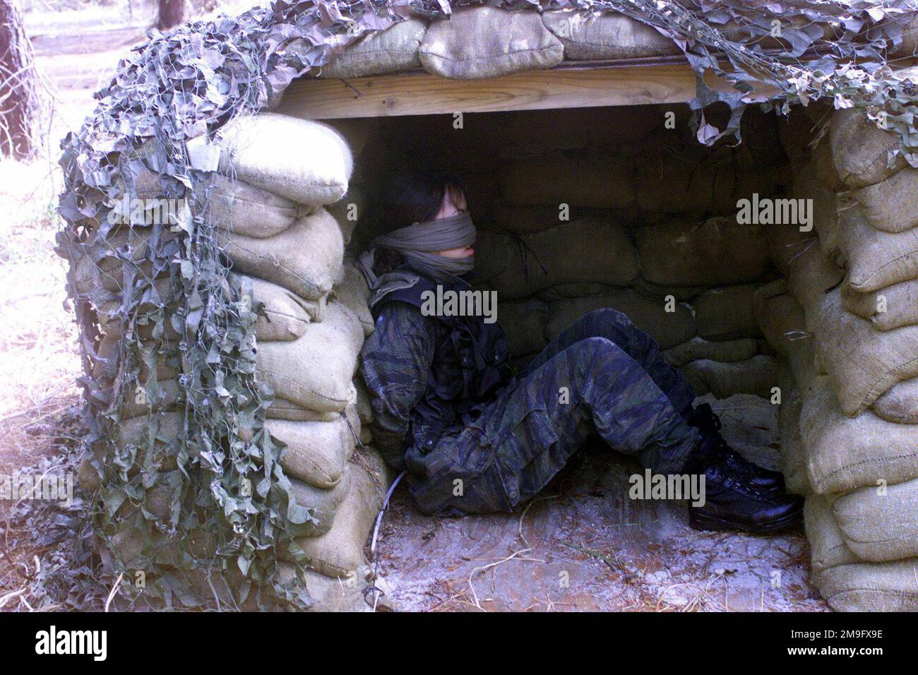 A female prisoner sits inside a detainment bunker, at the Security ...