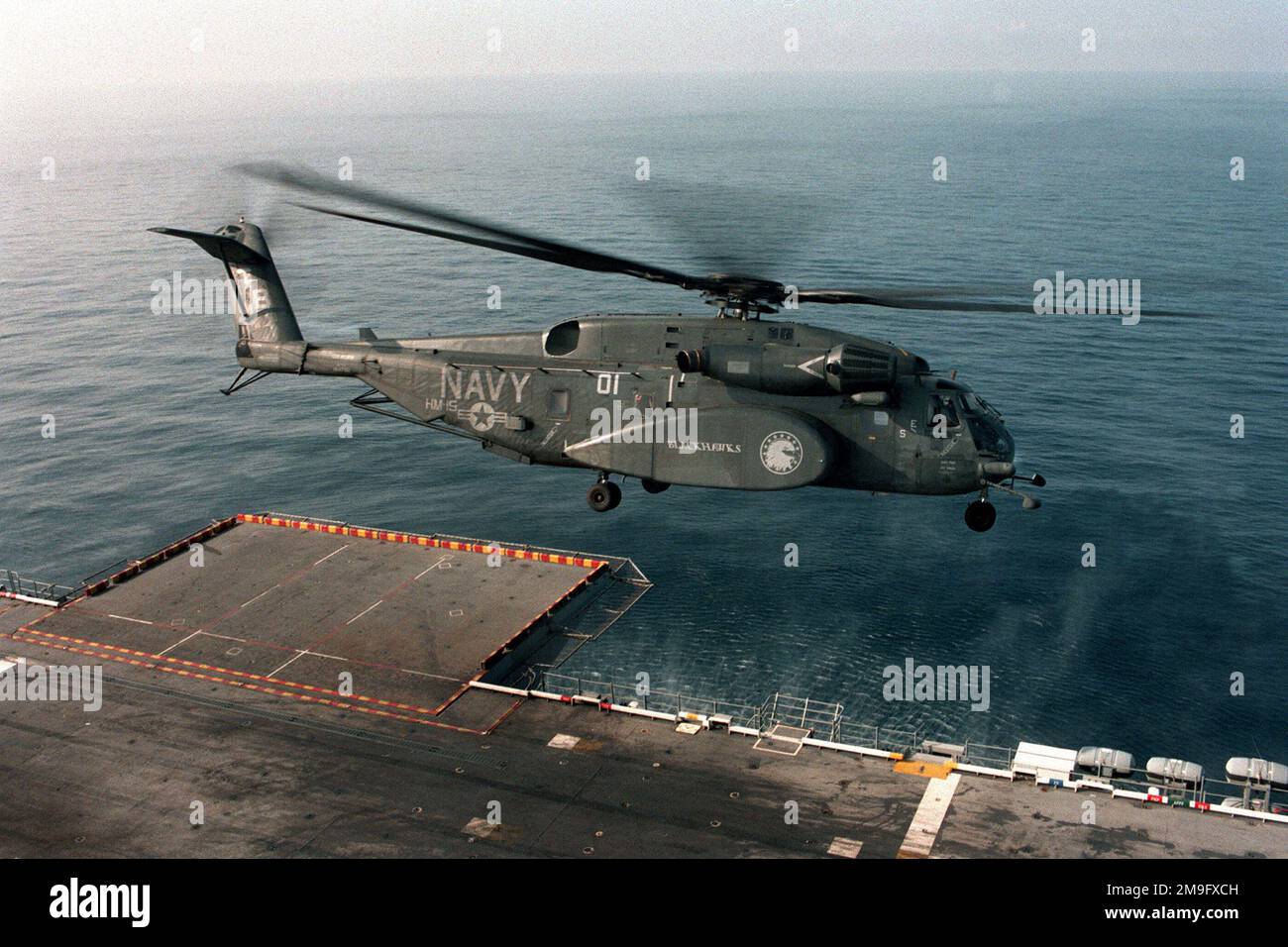 A US Navy CH-53 Helicopter takes off from the deck of the USS TARAWA ...