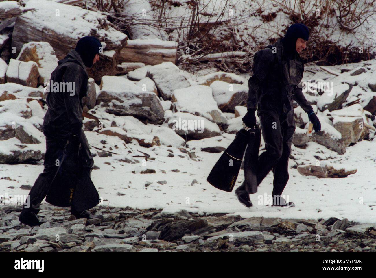 Trudging up the snow covered bank, Marines Captain Carl Shumacher and ...