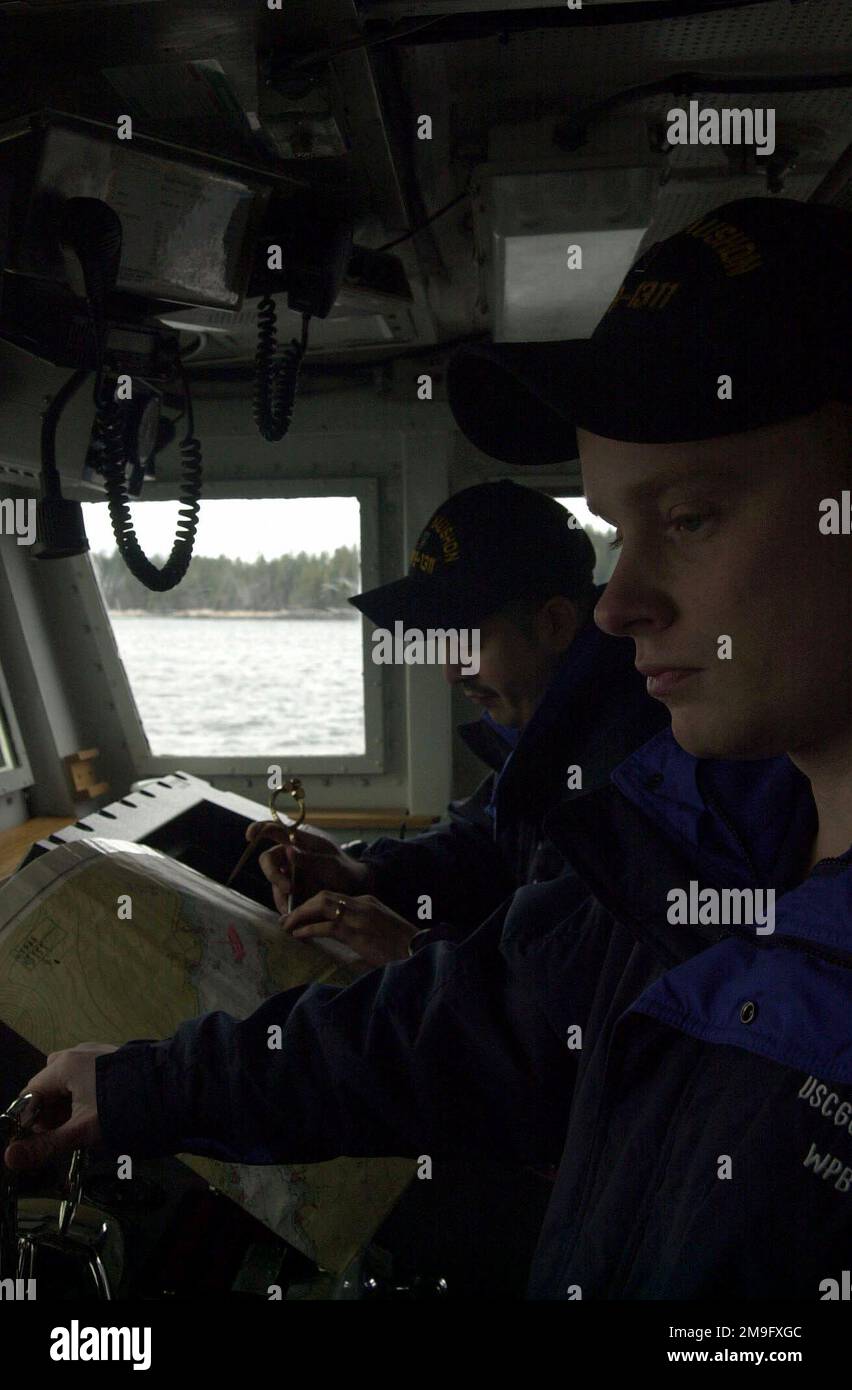 US Coast Guard Lieutenant Junior Grade John Larkin steers the US Coast ...