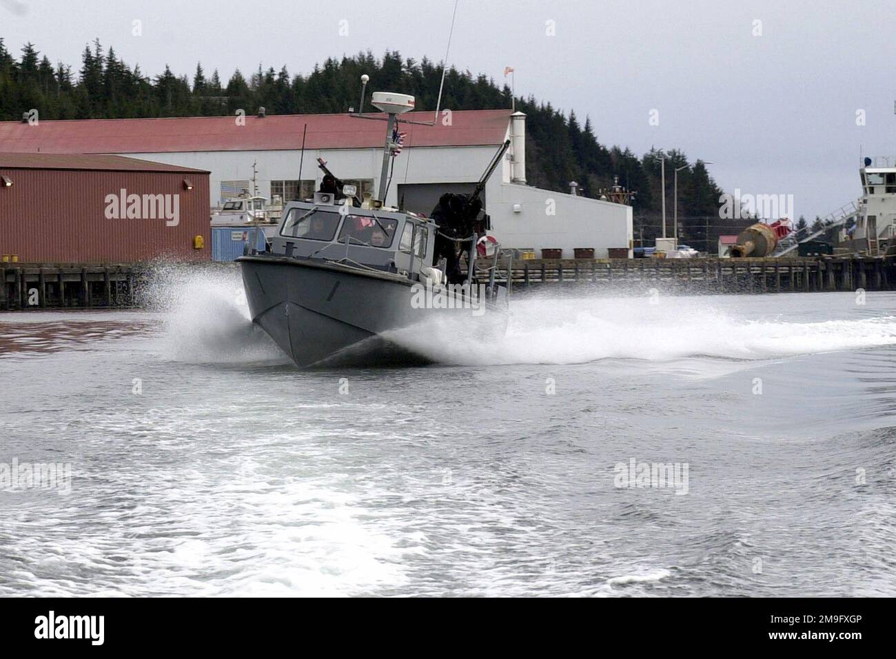 A boat from Navy Inshore Boat Unit 12, Seattle, Washington, provides ...