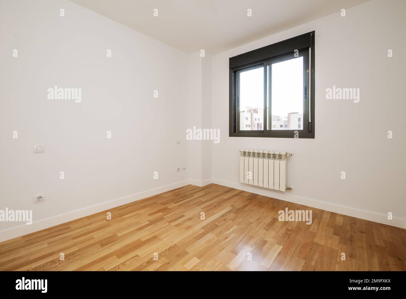 Room of an empty house with glossy oak parquet floors with black ...