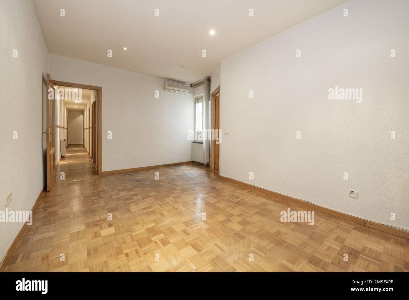 Room of an empty house with oak parquet flooring with slats laid out in ...