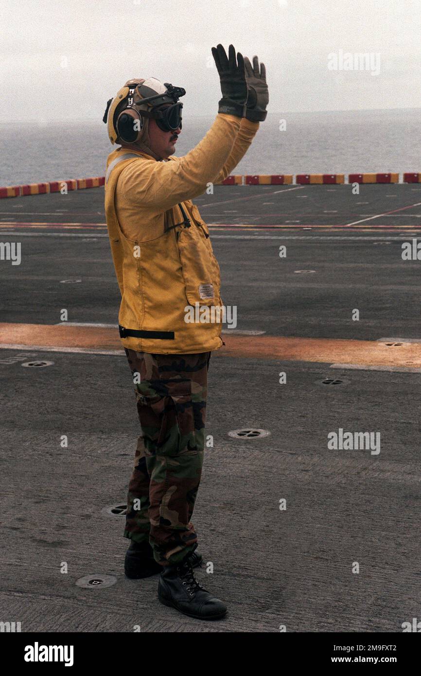 A US Navy Sailor directs traffic aboard the USS TARAWA (LHA 1) during ...