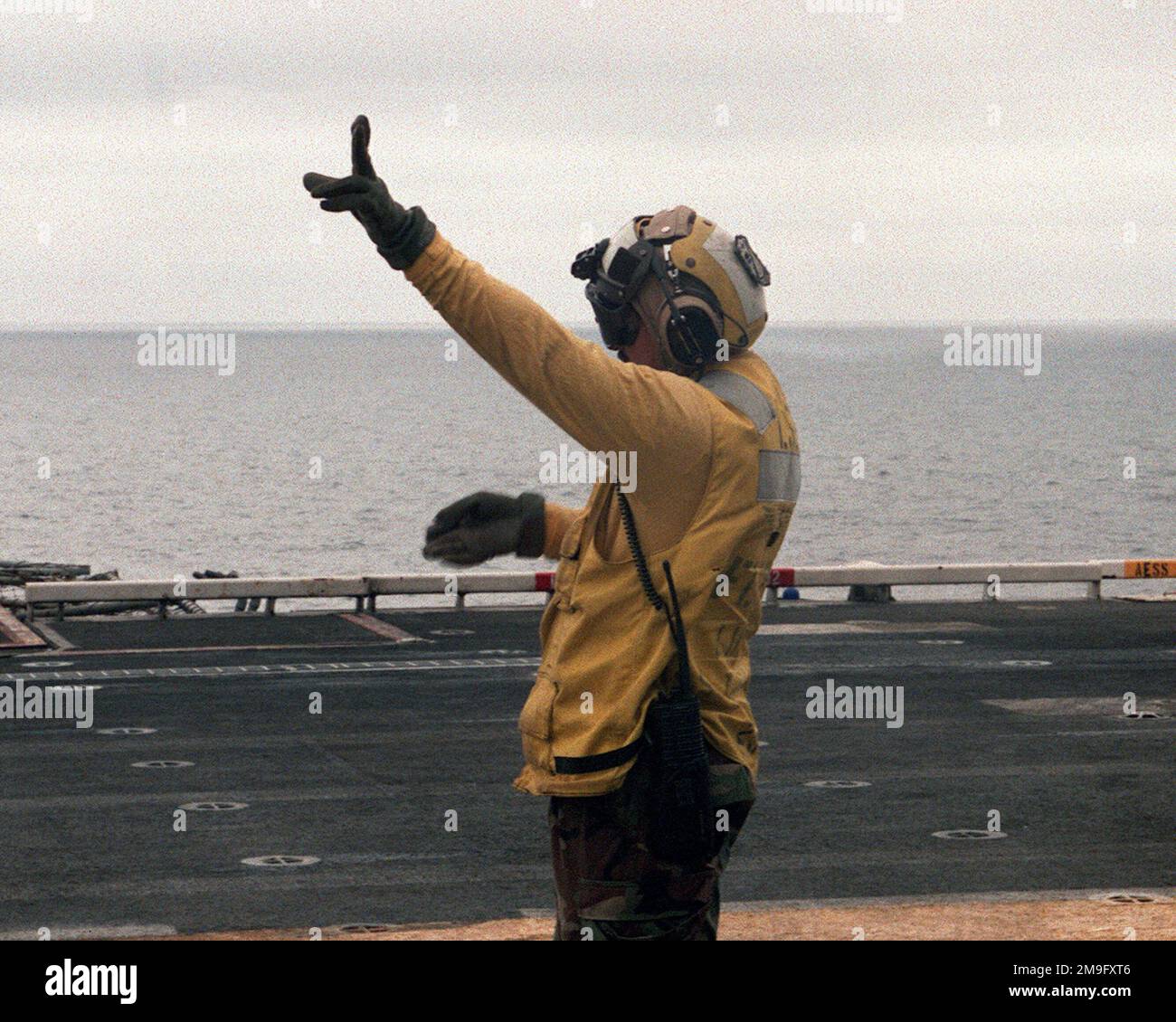 A US Navy Sailor directs traffic aboard the USS TARAWA (LHA 1) during ...