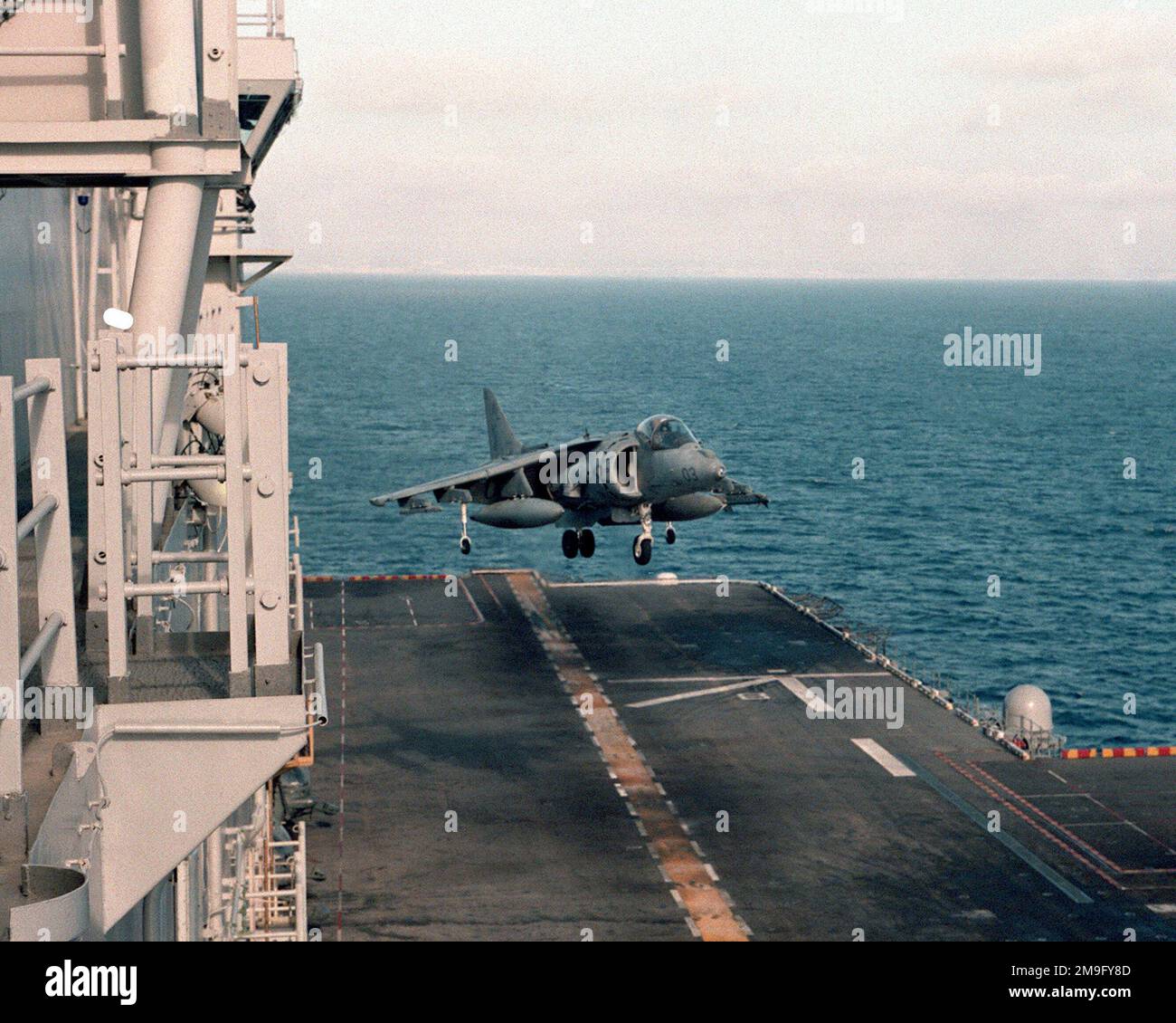 An AV-8B Harrier aircraft lands on the flight deck of USS TARAWA (LHA 1 ...