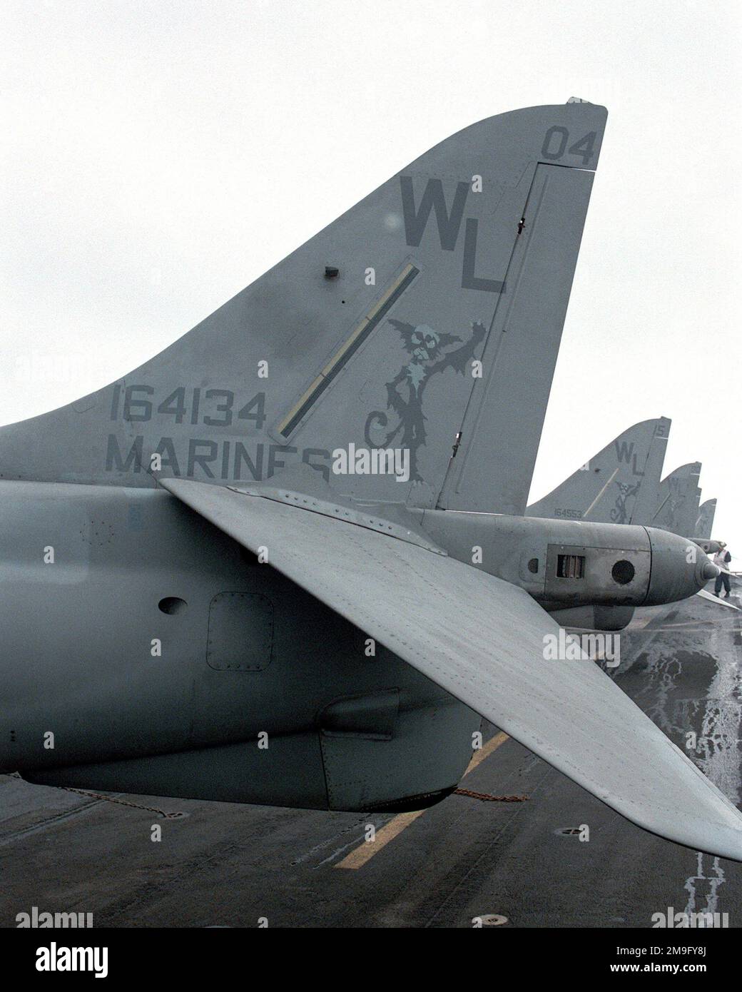 Shot of a row of AV-8B Harrier aircraft tails onboard the USS TARAWA ...