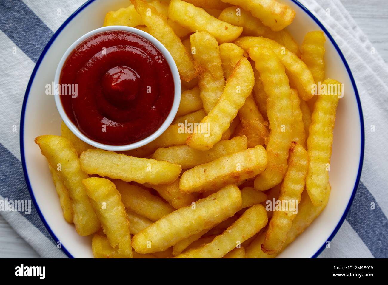 Homemade Unhealthy Crinkle French Fries with Ketchup on a Plate, top ...