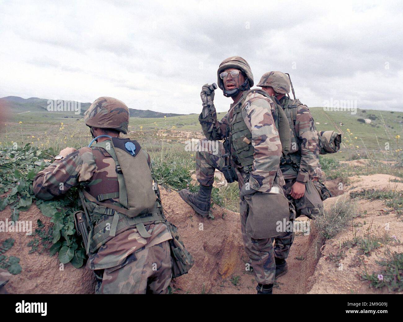 US Marine Corps (USMC) Major (MAJ) Douglas Zimbelman (center), uses the ...