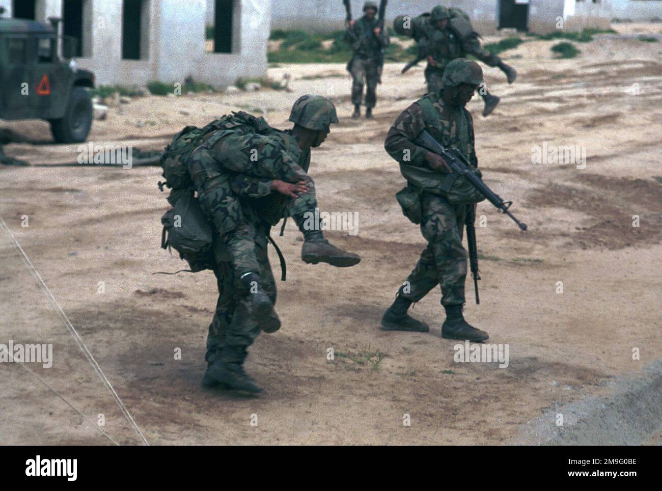 Using the firemans carry technique, US Marine Corps (USMC) personnel ...