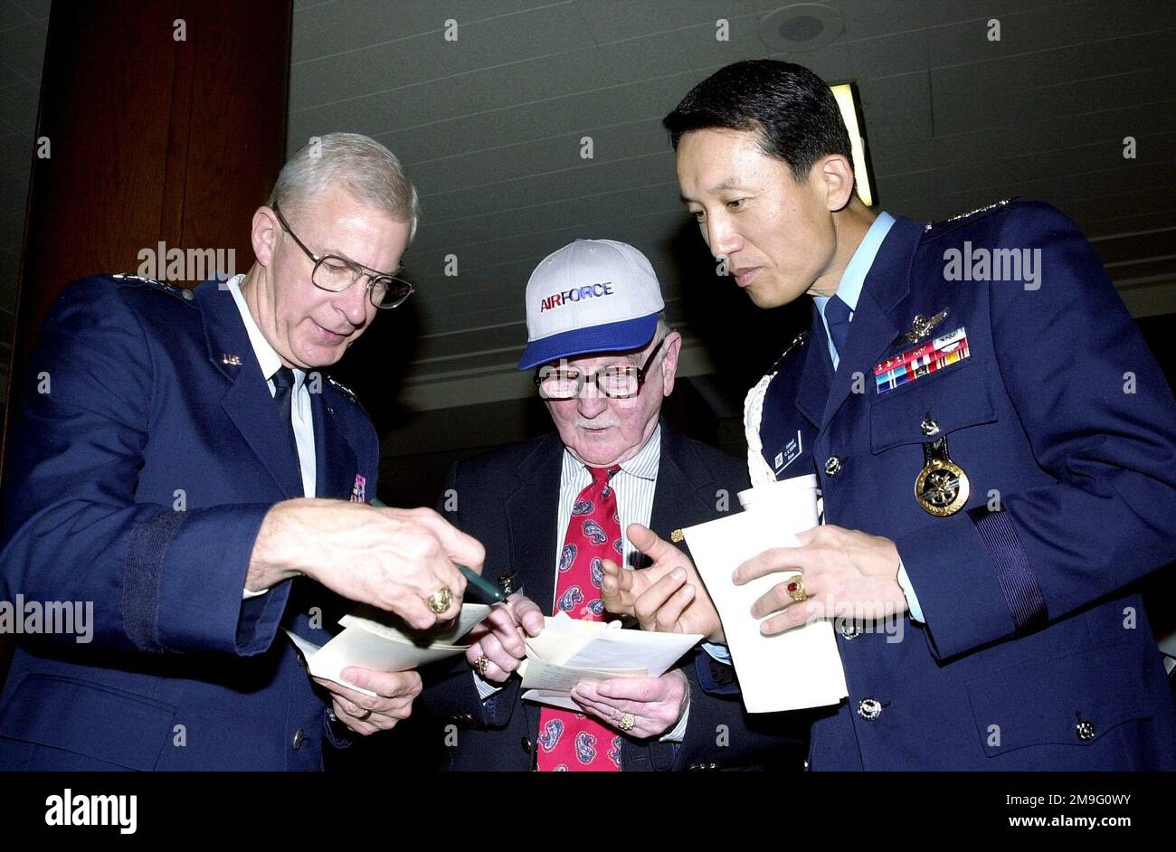 Mr. Hampton L. Hunt (center) shows Korean Air Force Colonel Choon Soon ...