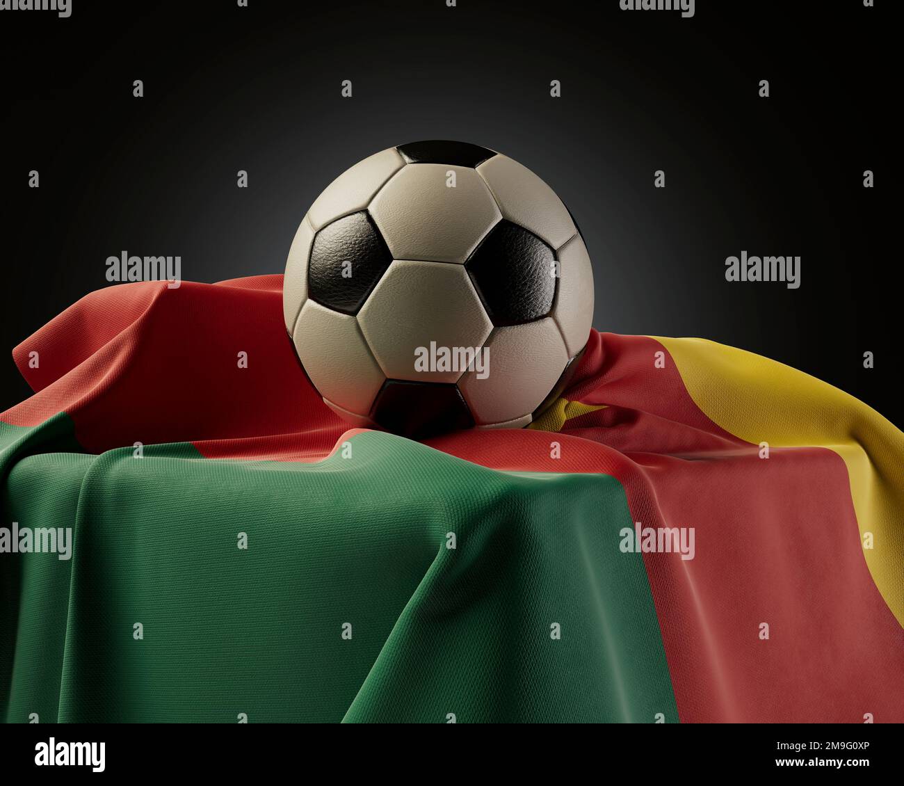 A regular soccer balls resting on a Cameroon flag draped over a plinth ...