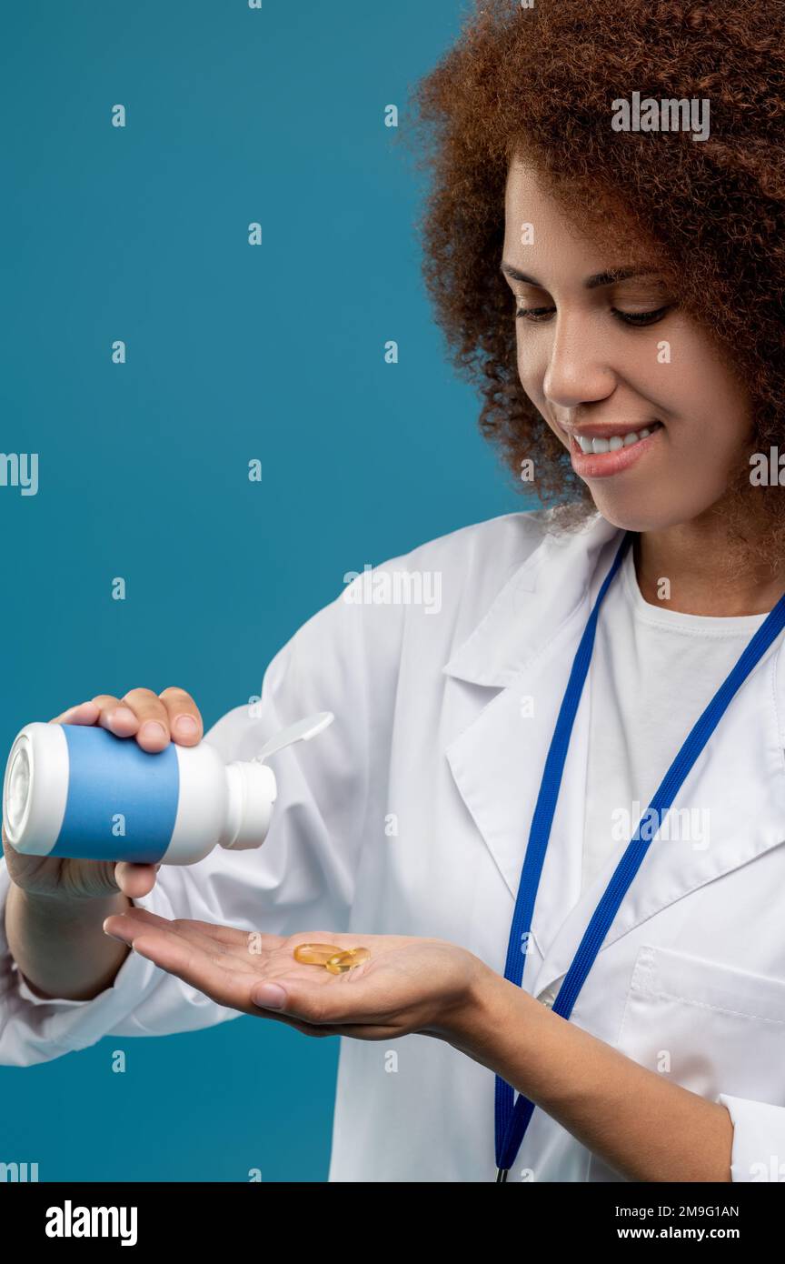 Young female doctor with jar of vitamins in hands Stock Photo - Alamy