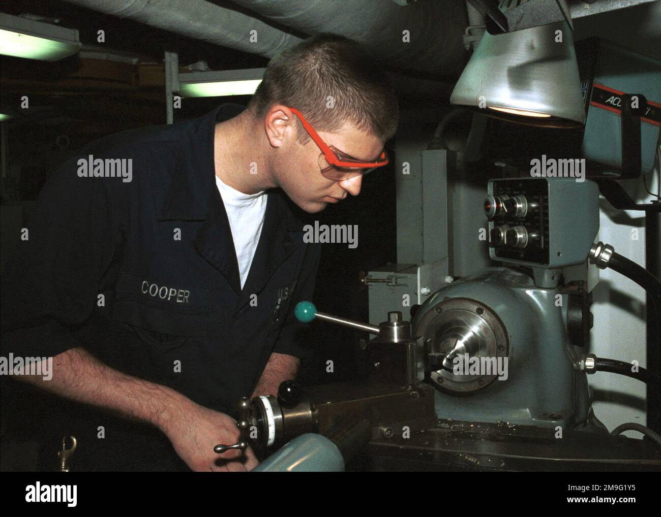 US Navy Machinery Repairman Fireman Dustin Cooper cuts a piece of a ...