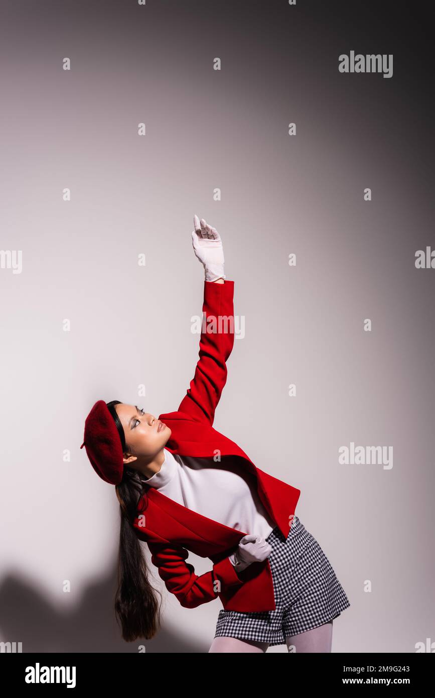 Young woman raising hand in hi-res stock photography and images - Alamy