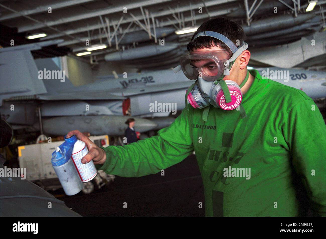 Aviation Machinist's Mate AIRMAN Shaun Todd dons a respirator while ...