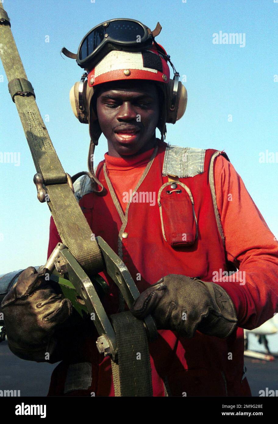 US Navy AIRMAN Kumba Calvin secures a sling during crash and salvage ...
