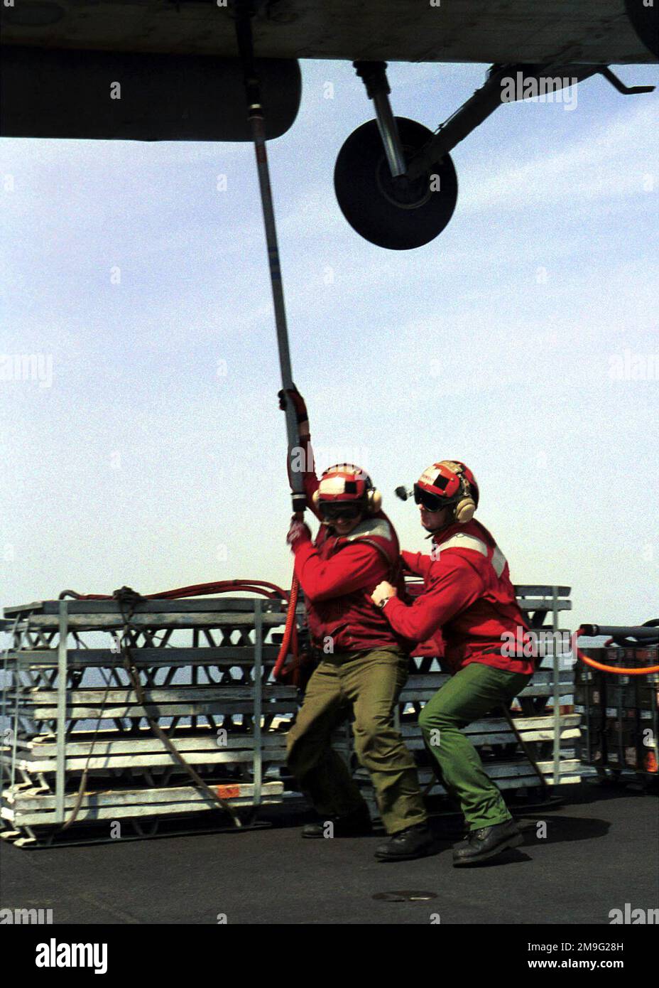 US Navy Aviation Ordnanceman Second Class Toby Snowden act as a saftey ...