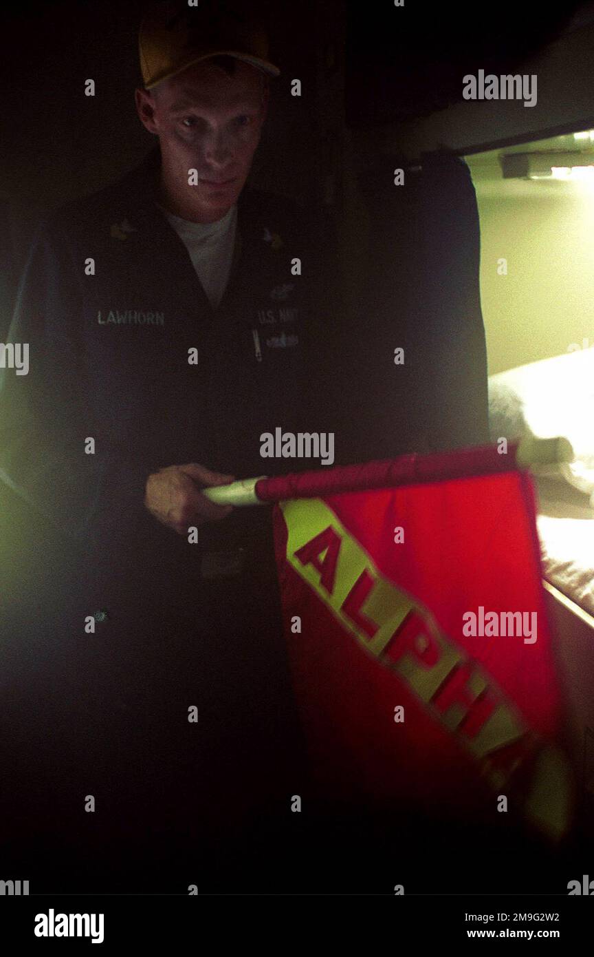 US Navy Photographer's Mate First Class Philip Lawhorn signals the ...