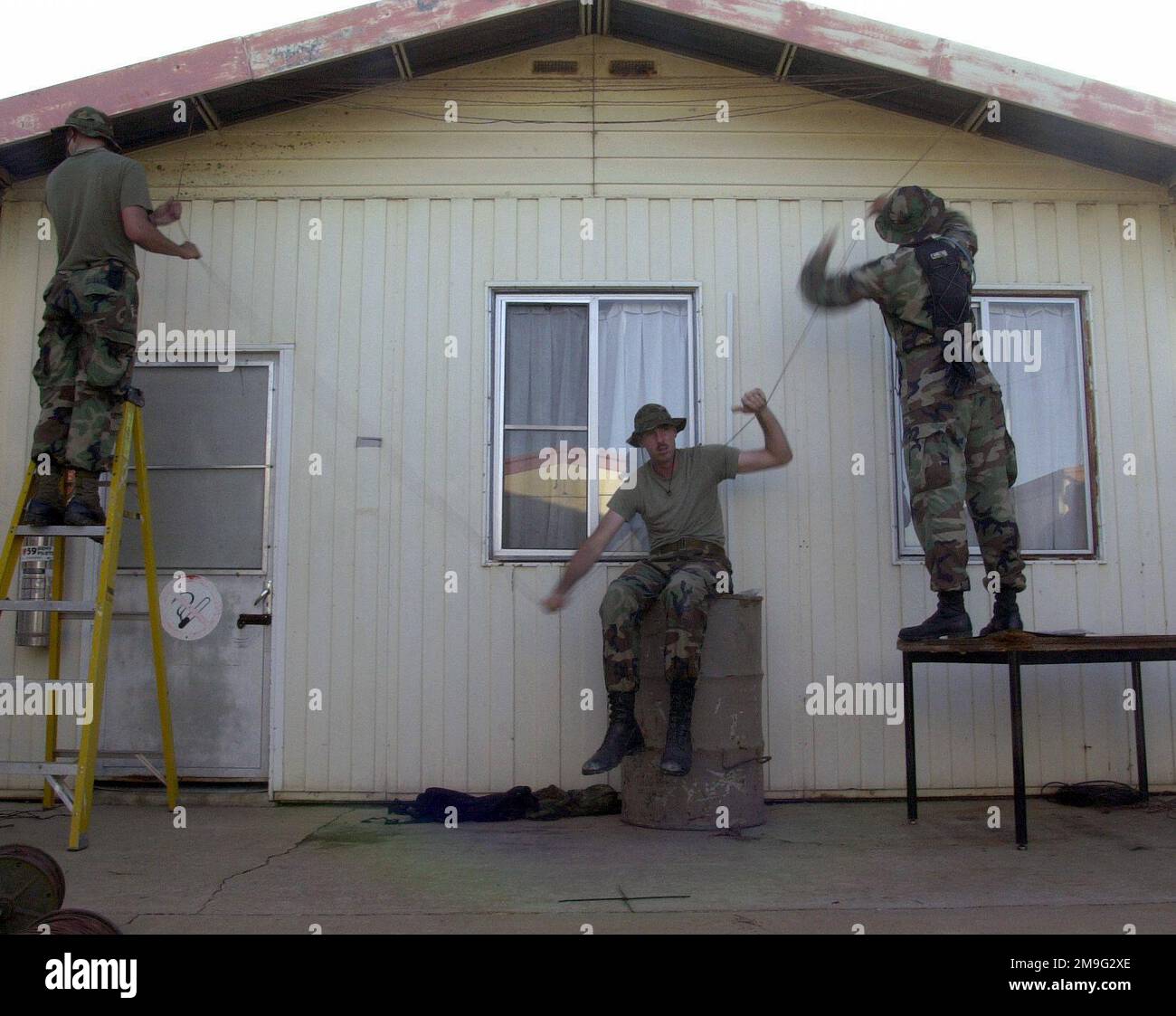 010427-F-1644L-001. [Complete] Scene Caption: Patching commercial phone ...