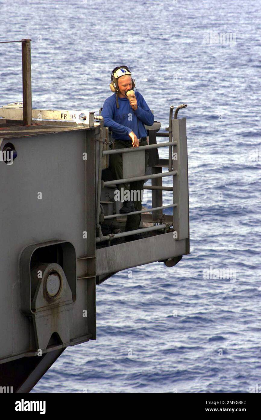 US Navy AIRMAN Patrick Martin communicates information between flight ...