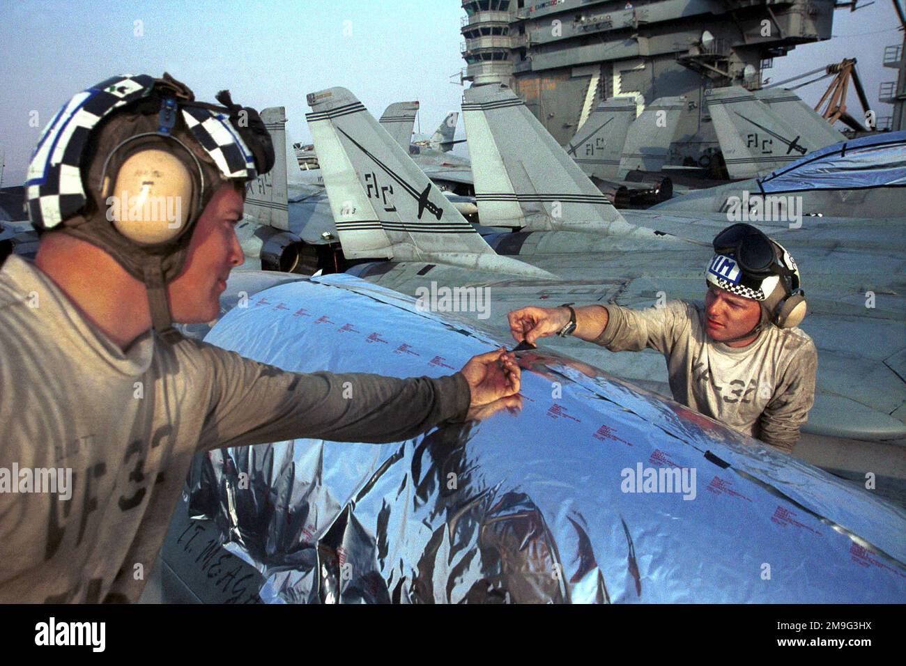 US Navy Aviation Machinist's Mate Third Class Daniel Elliott and US ...