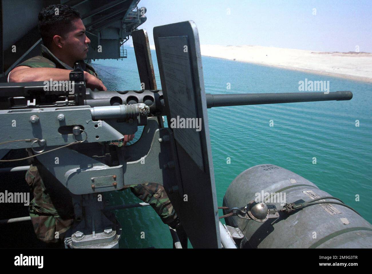 US Navy Aviation Ordnanceman Third Class Martin Gutierrez mans a fifty ...
