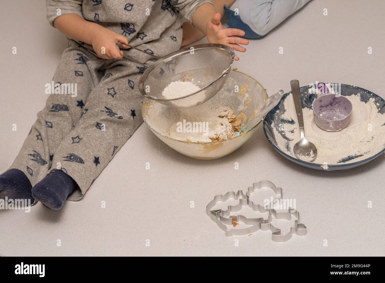 children adding flour to a large sieve for a cake mixture Stock Photo ...