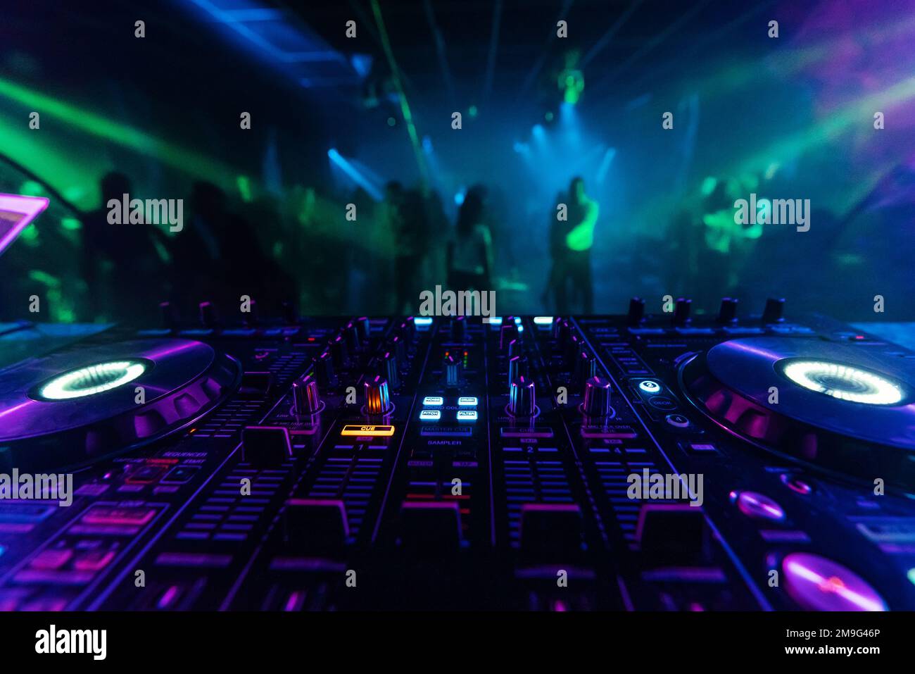 professional DJ mixer controller for mixing music in a nightclub with ...