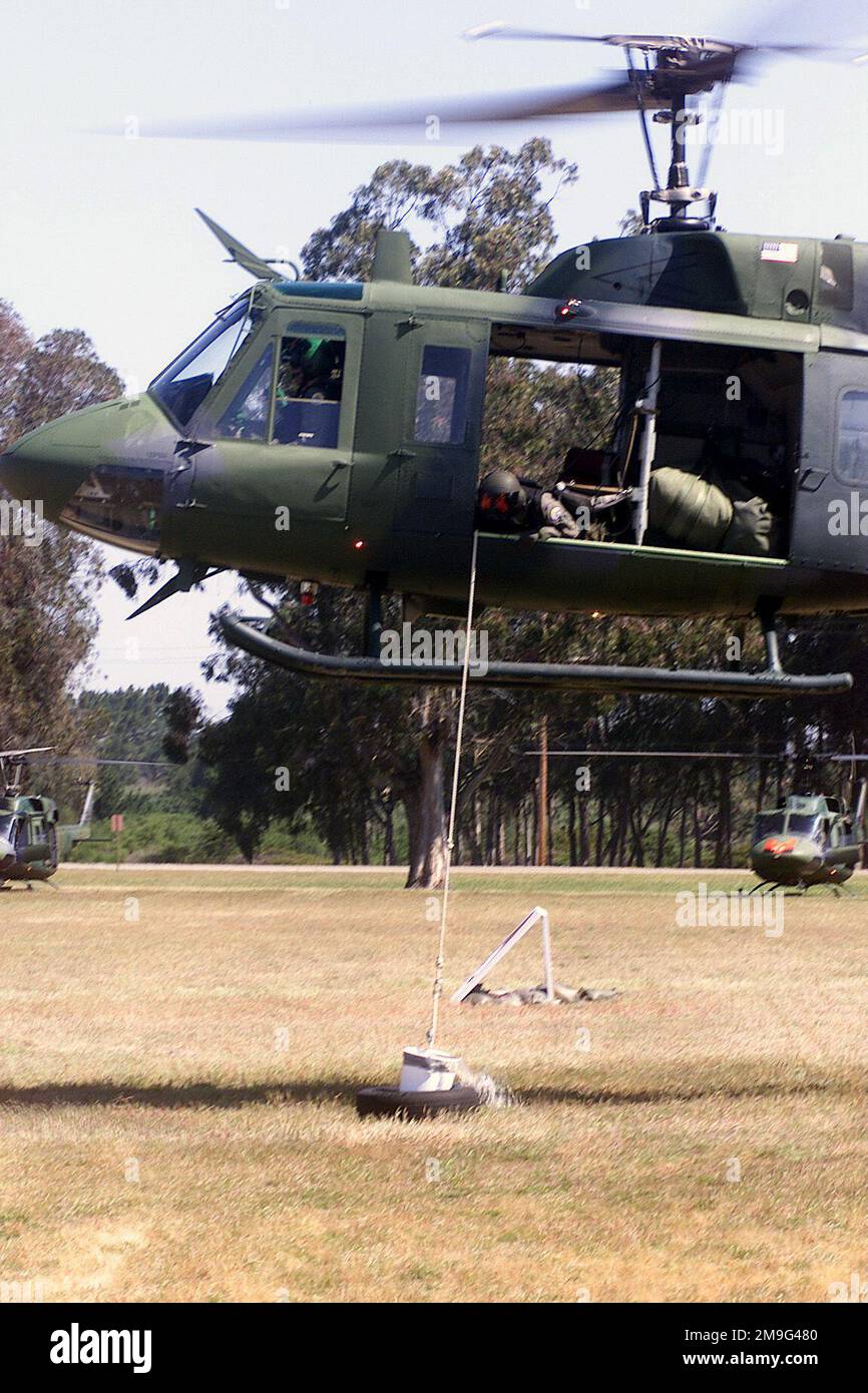 010508-F-7685H-021. [Complete] Scene Caption: Guiding the UH-1N ...