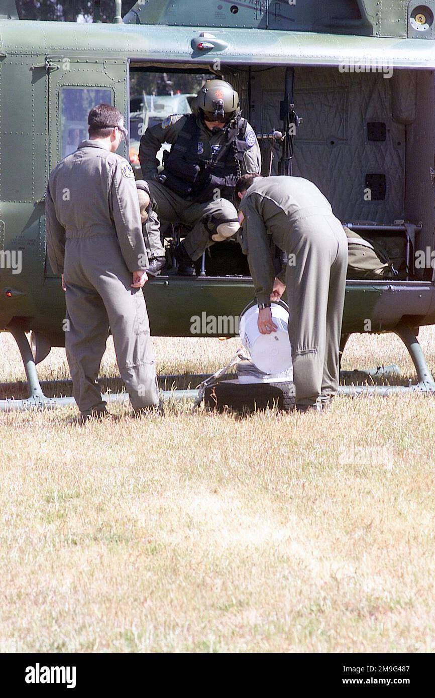 010508-F-7685H-017. [Complete] Scene Caption: Two evaluators pour water ...