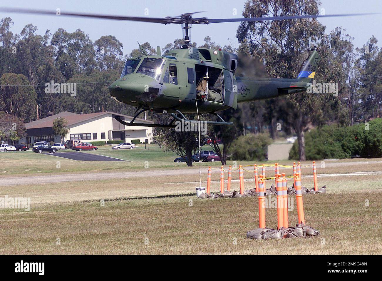 010508-F-7685H-019. [Complete] Scene Caption: Guiding the UH-1N ...