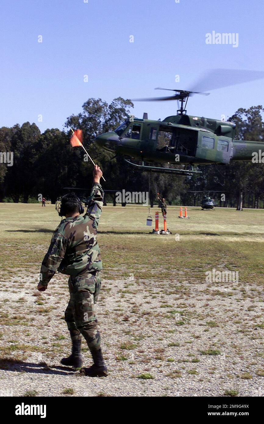 010508-F-9753B-014. [Complete] Scene Caption: The crew of the UH-1N ...