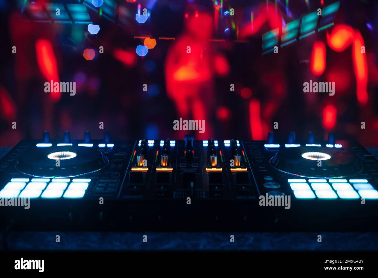 professional DJ controller for mixing electronic music in a nightclub ...