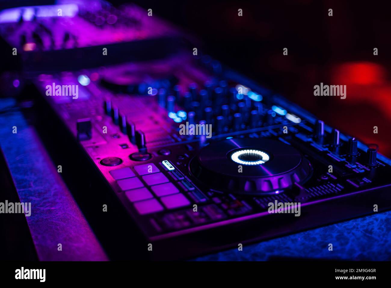 professional DJ controller for mixing electronic music in a nightclub ...