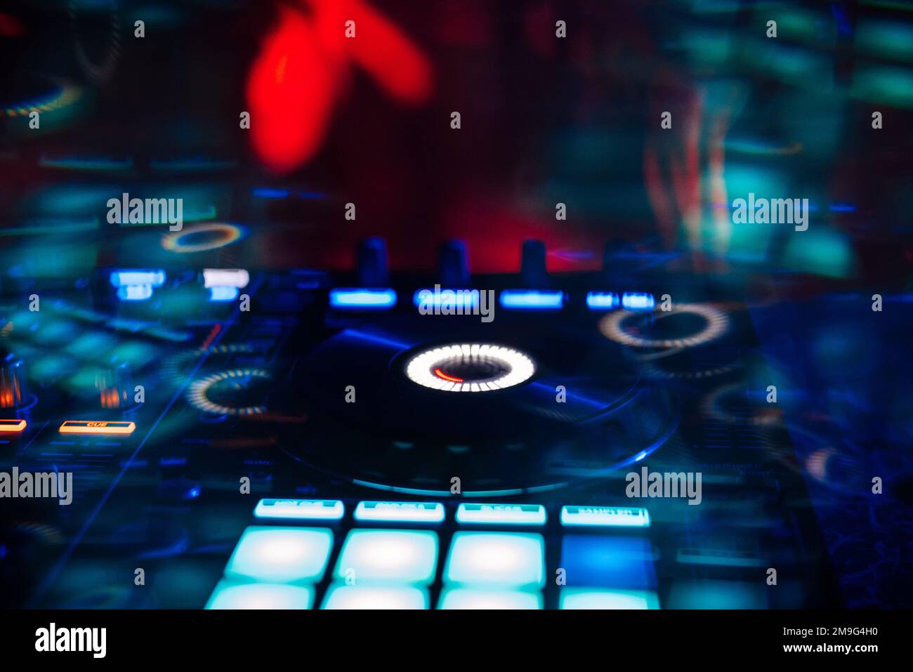 professional DJ mixer controller for mixing music in a nightclub with ...