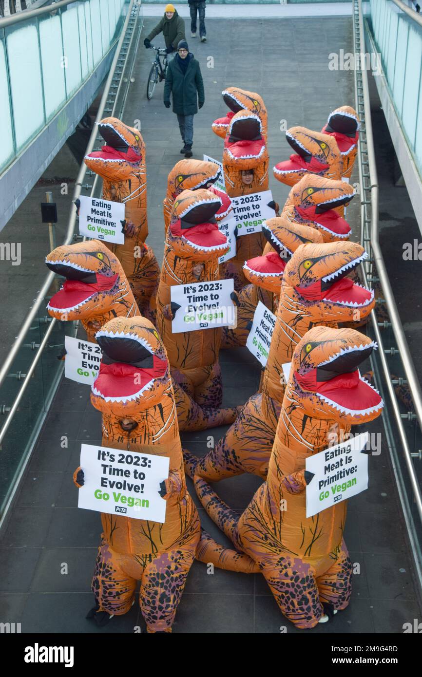 London, England, UK. 18th Jan, 2023. PETA activists wearing dinosaur costumes urge people to go ...