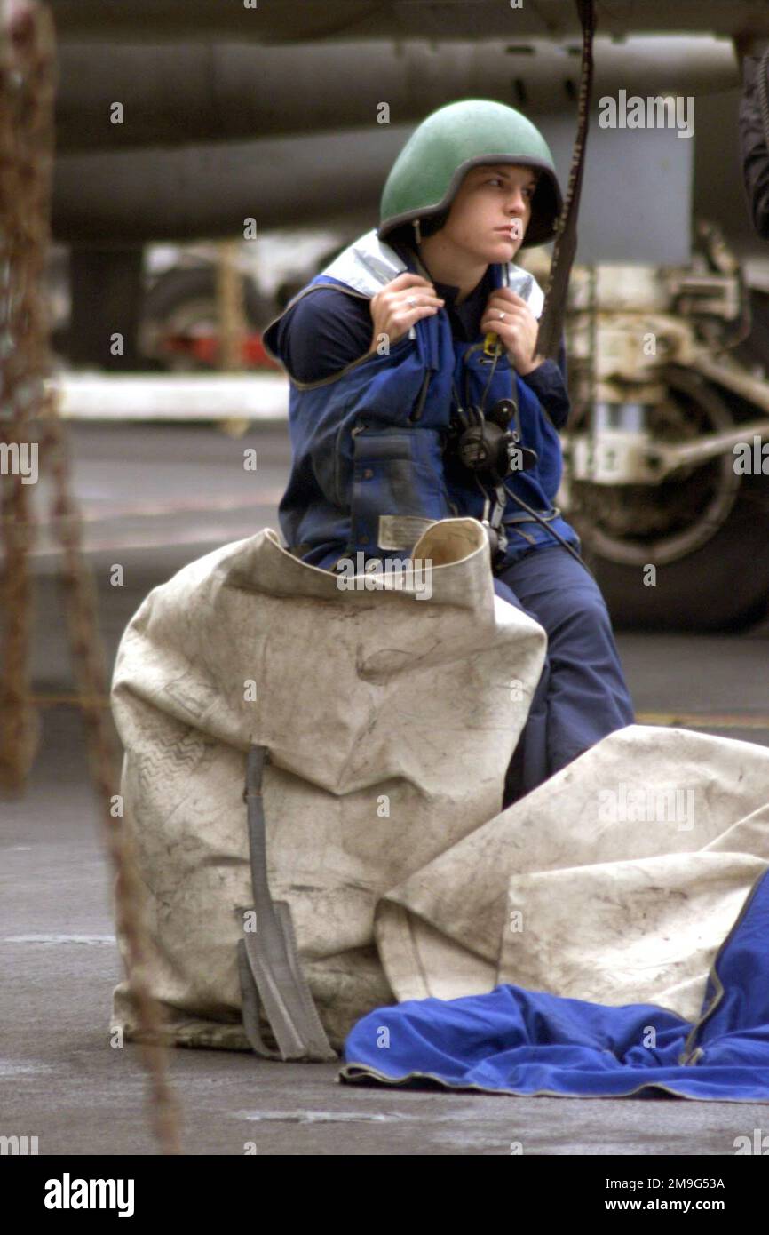 US Navy SEAMAN Blaire Mammel stands watch as phonetalker in the hangar ...