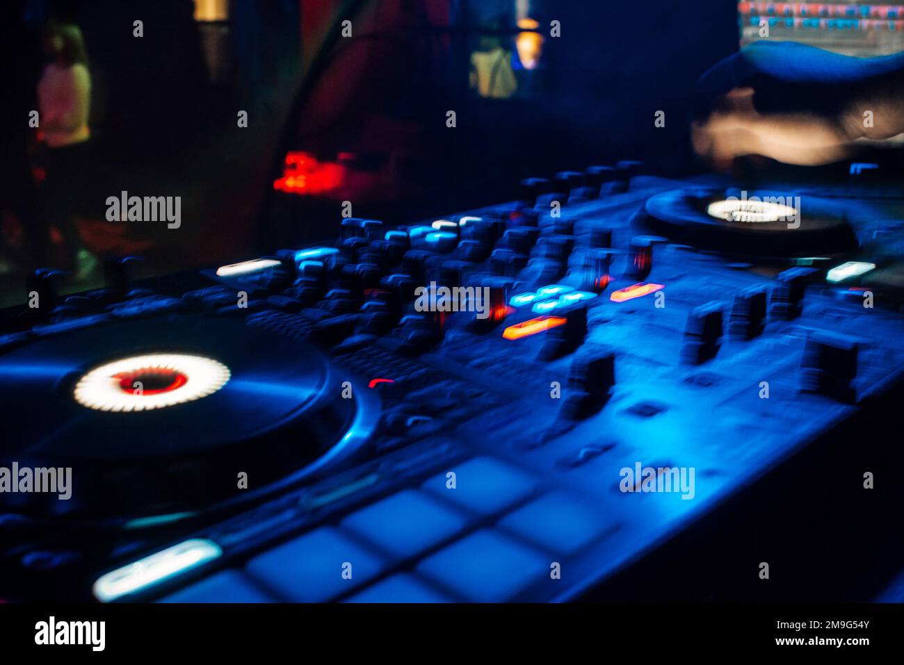 professional DJ mixer controller in night club with motion and blur ...