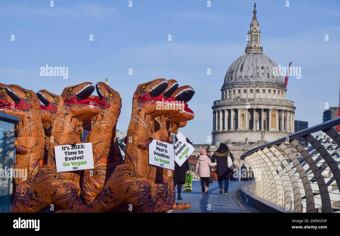 London, England, UK. 18th Jan, 2023. PETA activists wearing dinosaur costumes urge people to go ...