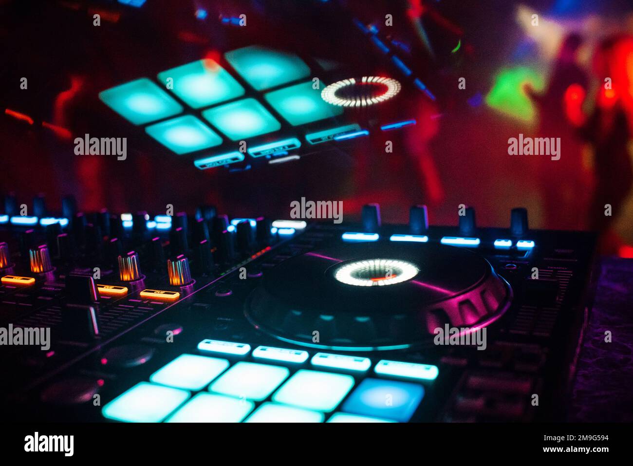 professional DJ mixer controller for mixing music in a nightclub with ...