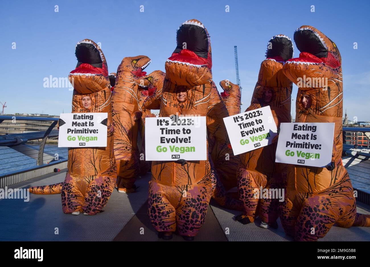 London, England, UK. 18th Jan, 2023. PETA activists wearing dinosaur costumes urge people to go ...