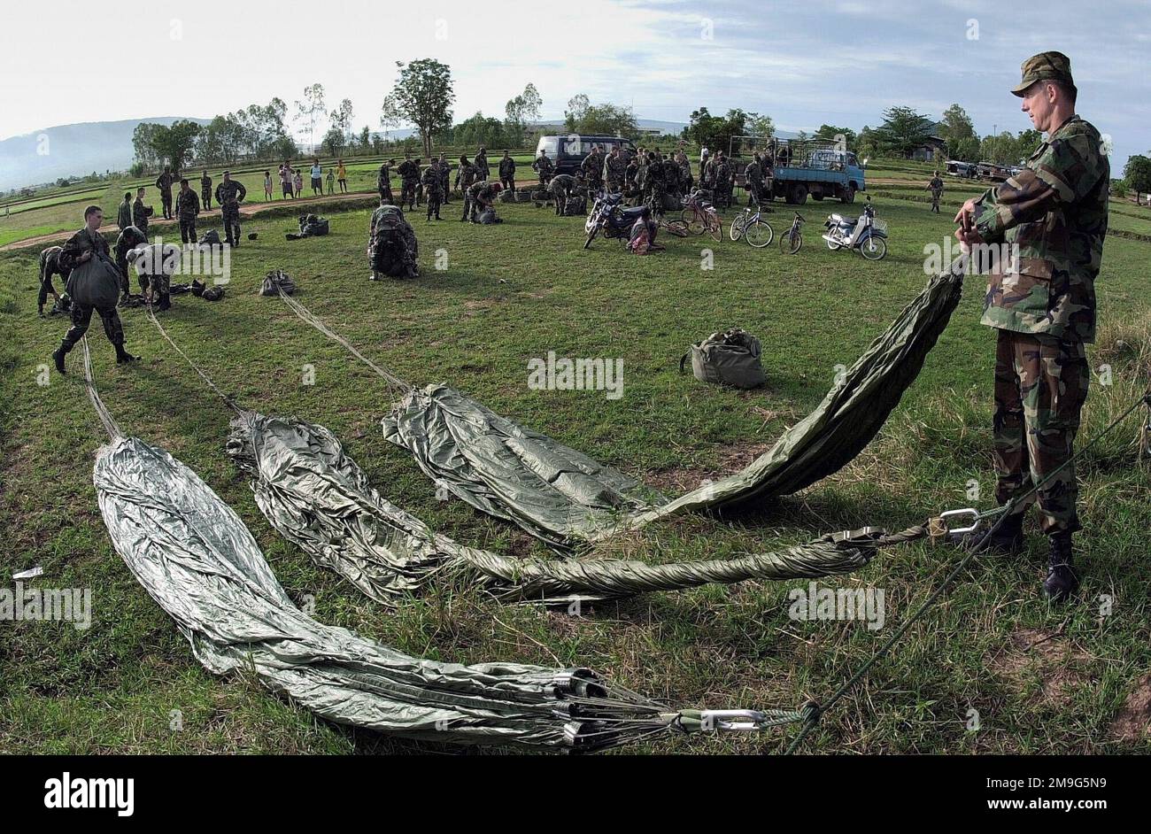 US Army services members field dress and store their parachutes after ...