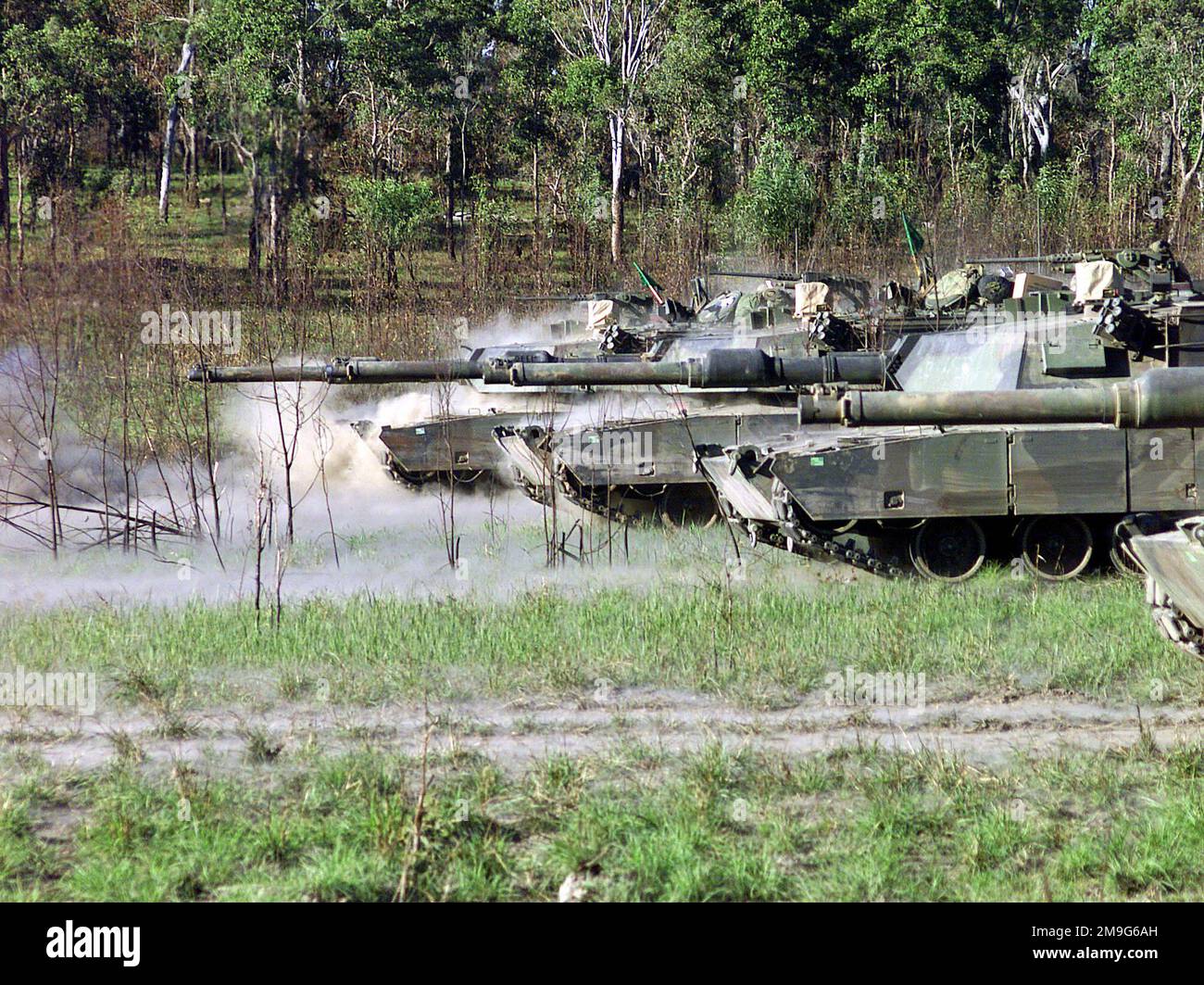 An M1A1 Abrams tank sends rounds down range during a live fire exercise ...