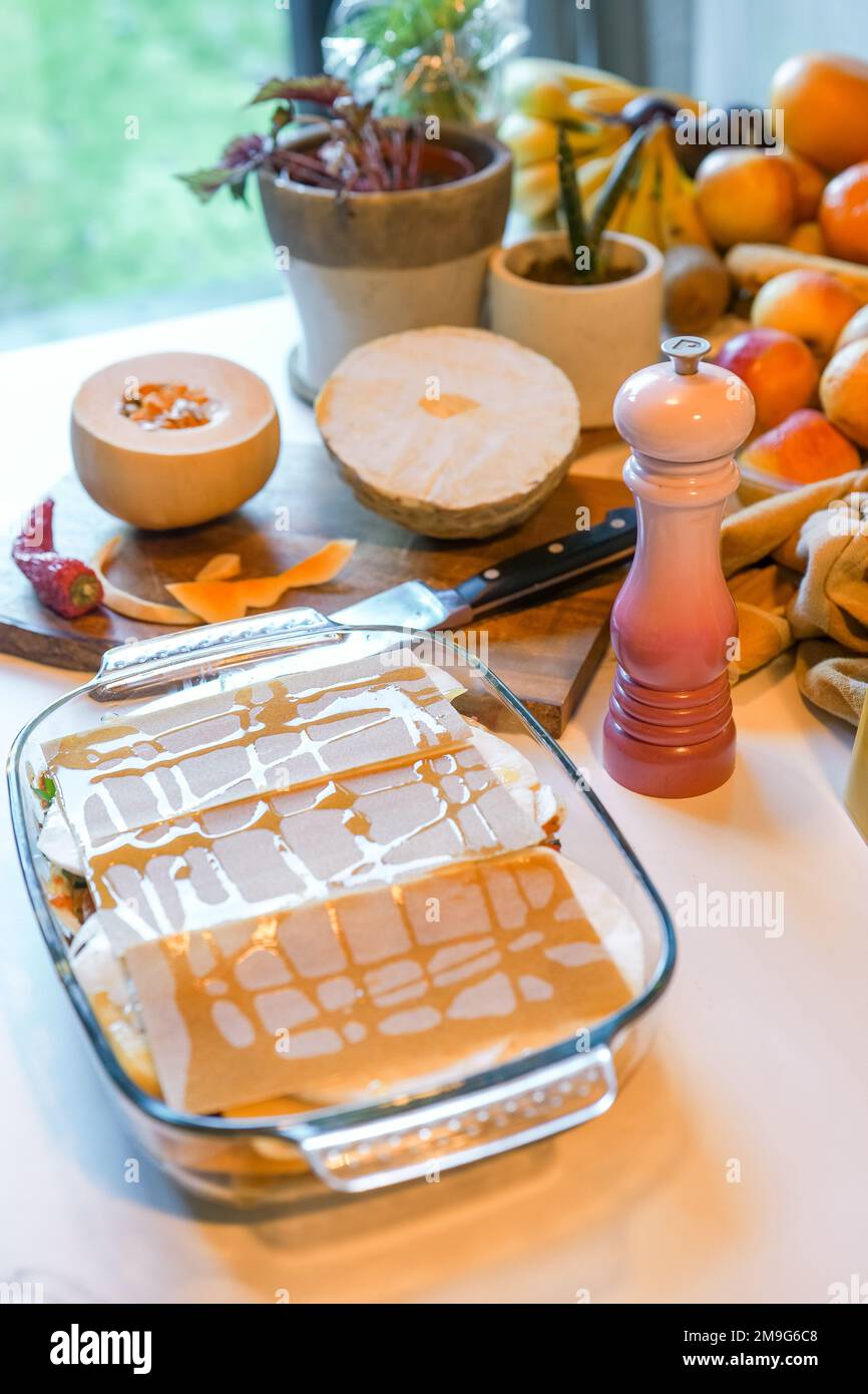 Cooking winter lasagna with fresh winter vegetables in home kitchen on ...