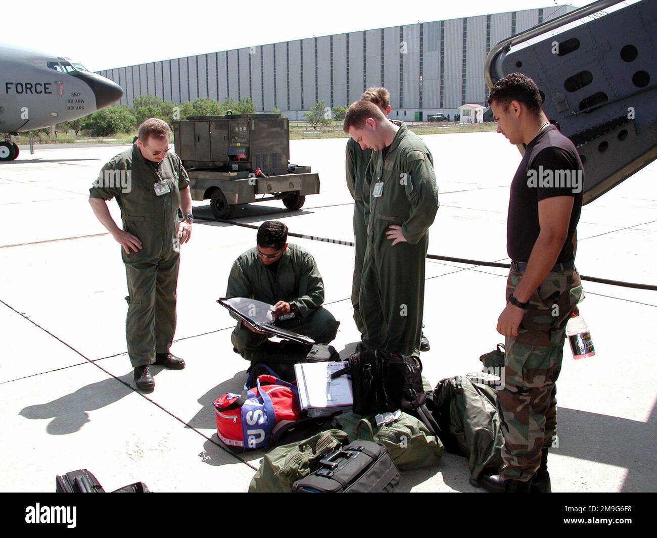 Captain (CAPT) Sushil Ramrakha, USAF, (kneeling), a KC-135 Stratotanker ...